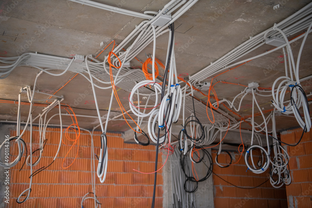 interior of skyscraper floor under construction. Cables, pipes and ...