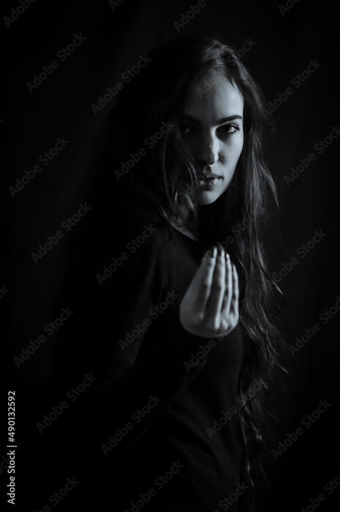 Portrait of a beautiful young Italian woman with very long hair making ...