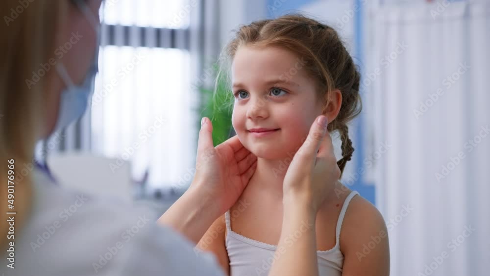 Young male doctor checking little girl's tonsils in his office. Stock ...