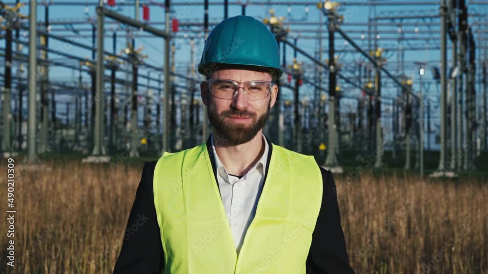 Vídeo do Stock: Portrait of young electric engineer wearing helmet suit ...