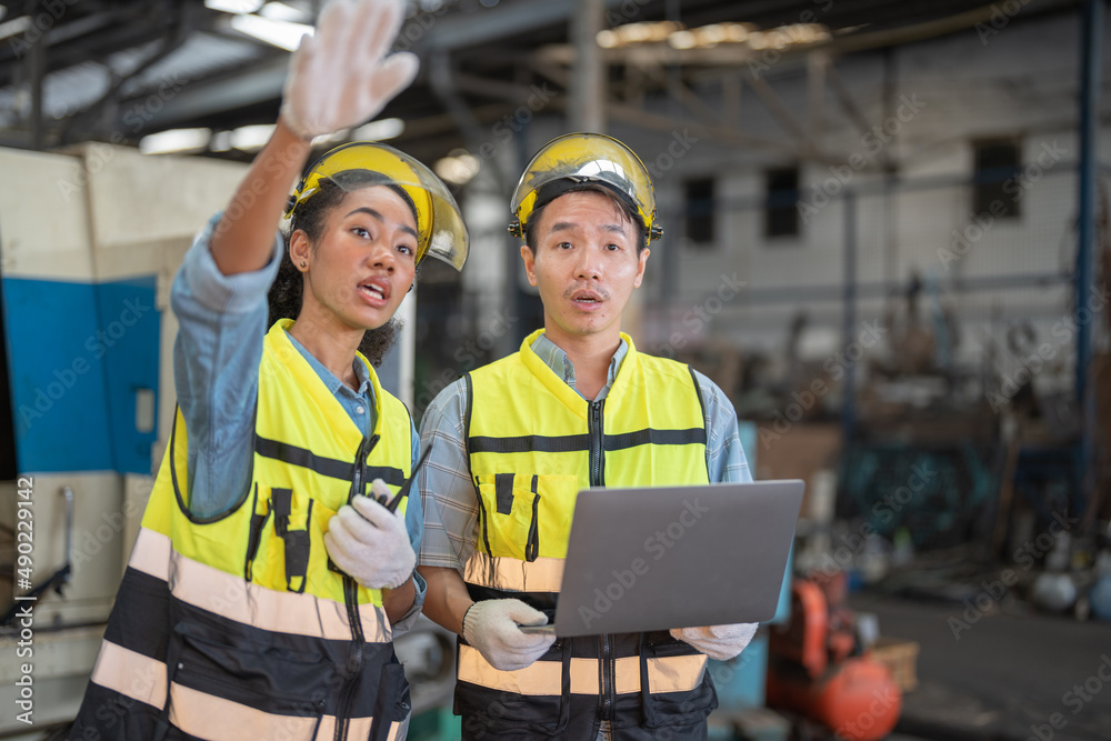 Professional engineering workers walk and check in warehouse factory ...