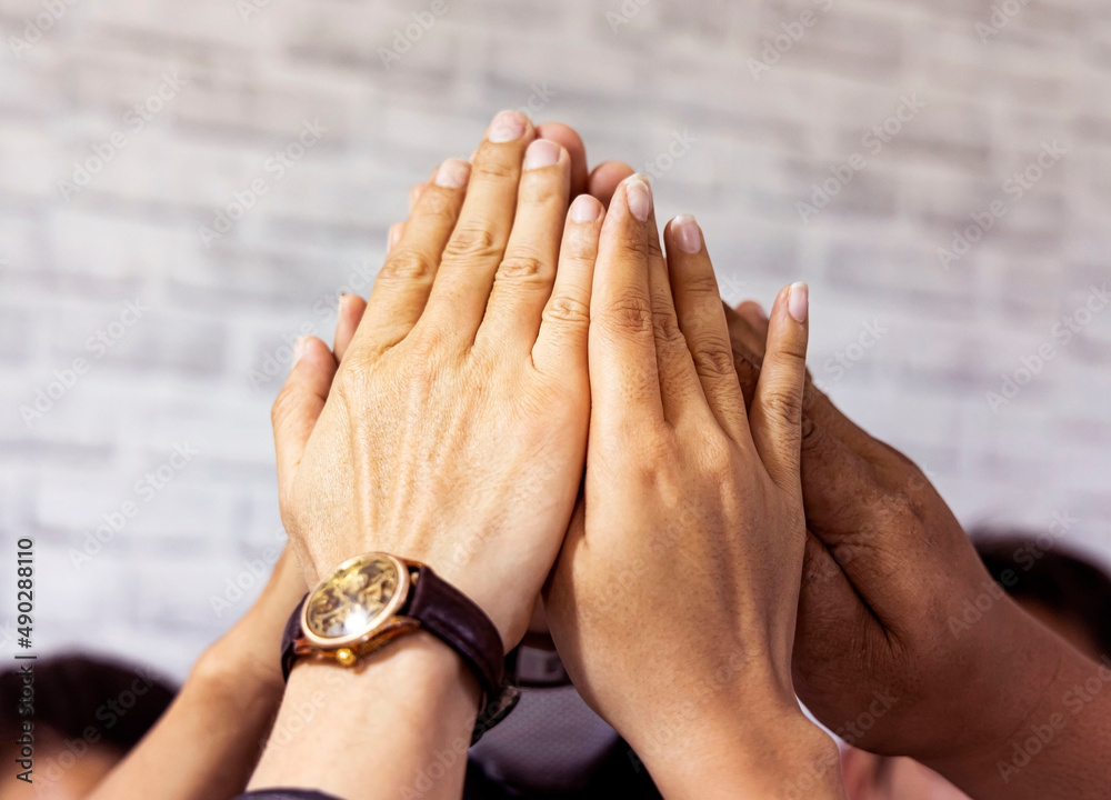 Selective focus of hands in hi five team work which hands of team , the ...