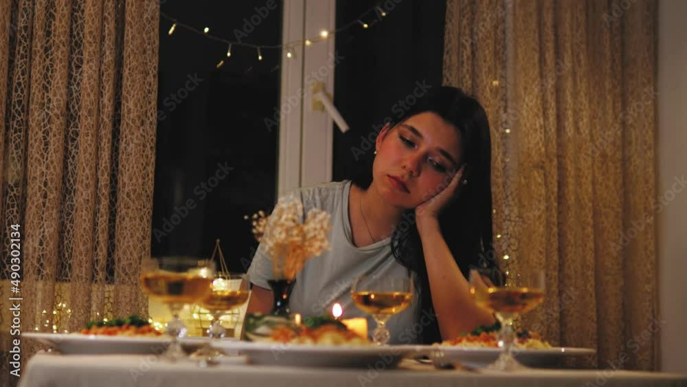 Lonely sad depressed young female waiting friends guests sitting at ...