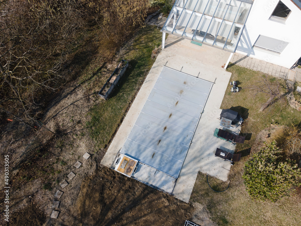 Drone flight over a covered pool with a tarp that is still under ...