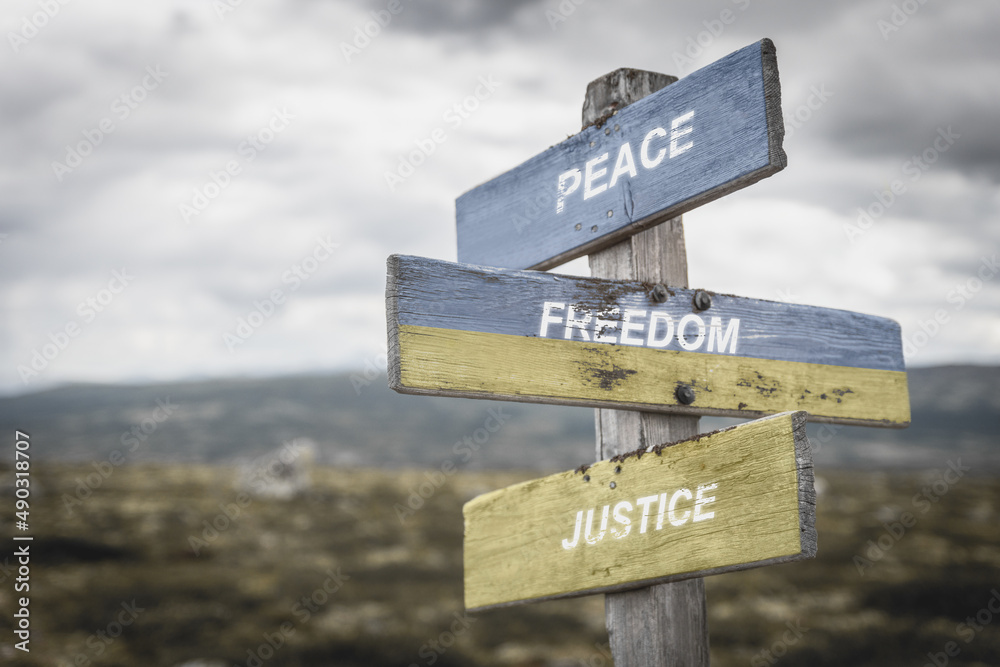 peace freedom justice text quote on wooden signpost outdoors, written ...