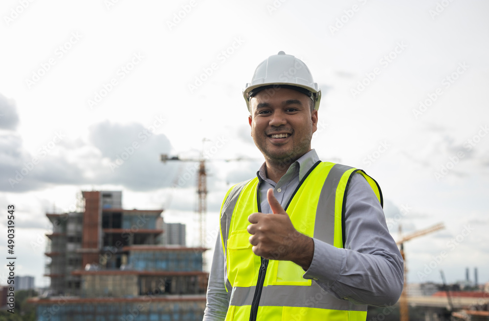 Asian engineer man or architect looking forward with white safety ...