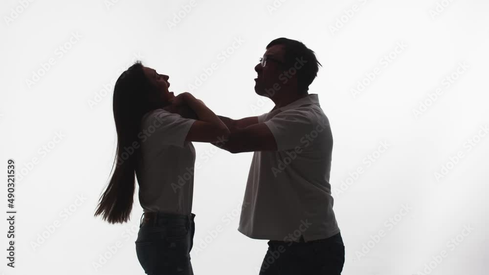 Video Stock Silhouette of man from rage and anger strangling woman ...