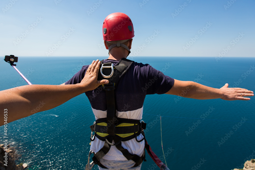 Rope jumping off a cliff with a rope in the water. The ocean. Sea ...