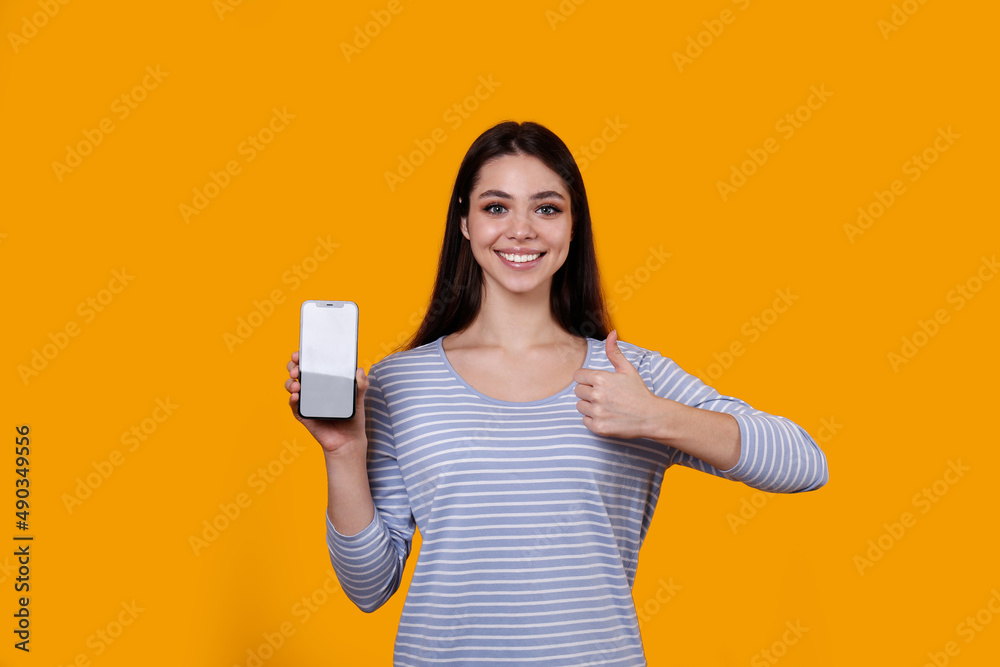 Young beautiful brunette woman with long hair wearing striped shirt ...