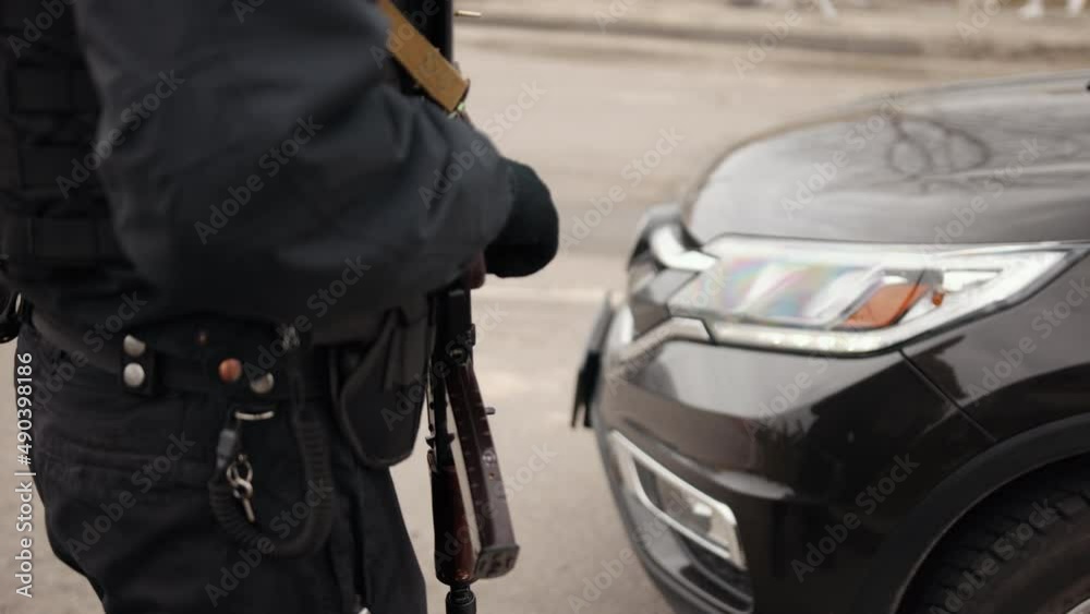 Members of police strategic response group stand guard. Man in black ...