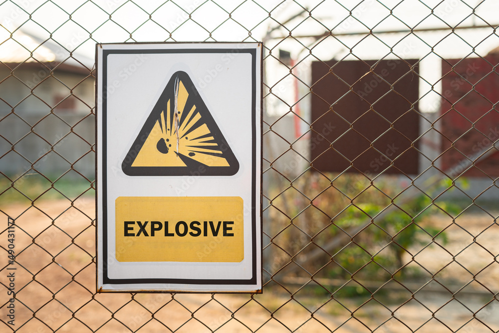 "Explosive" caution information metal sign plate on the wire fence ...