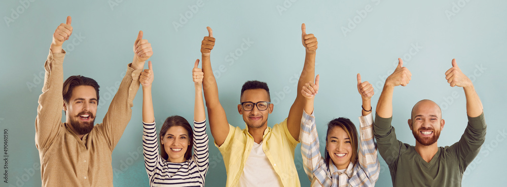 Young people with approving expression looking at camera showing ...