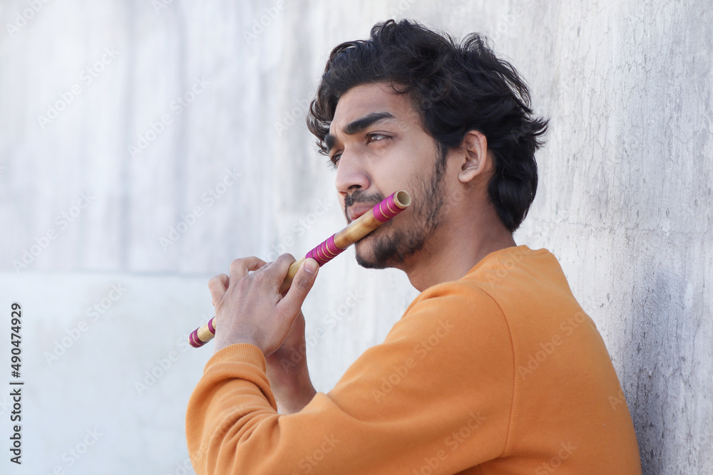 Indian boy playing bansuri Indian Bamboo Flute. Stock Photo | Adobe Stock