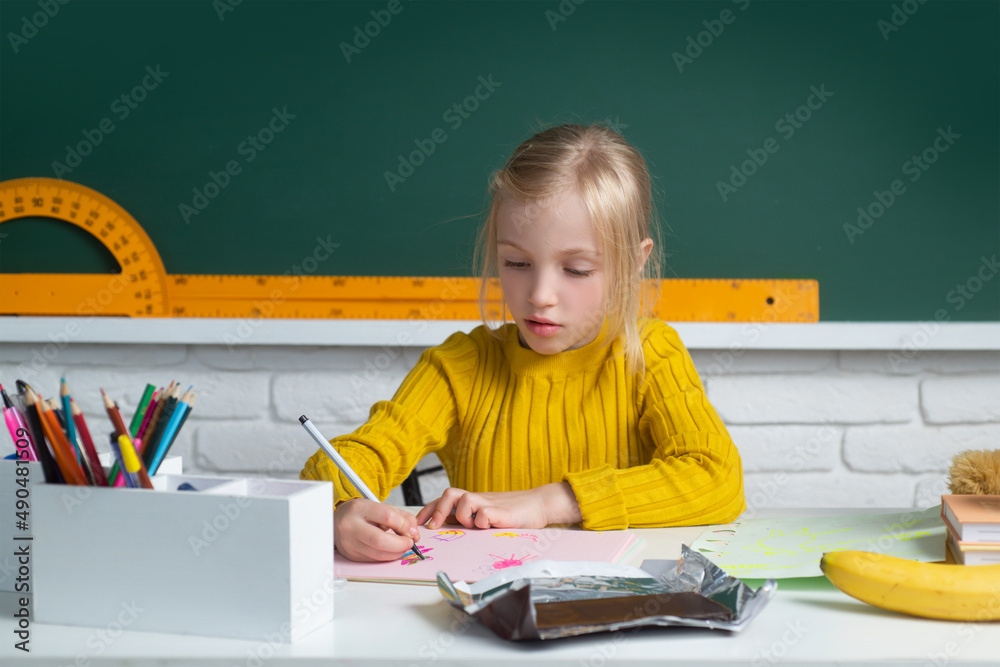 Kid girl learning lesson at school. Elementary school child in class ...