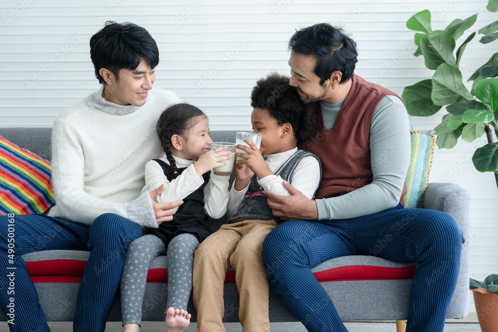 Happy young Asian gay couple with diverse adopted children African and ...