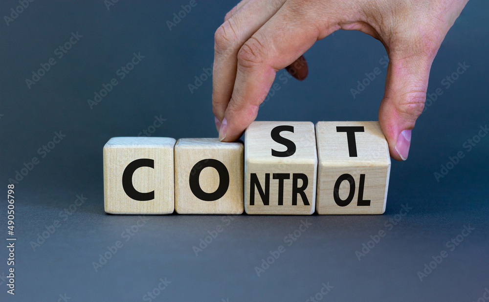 Cost control symbol. Businessman turns wooden cubes and changes the ...