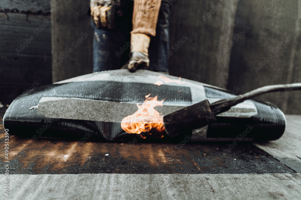 Poster Construction workers installing bituminous membrane ...