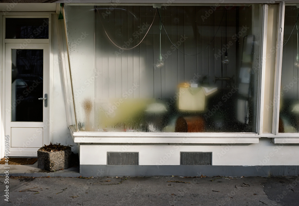 closed shop front view of window with wetness on the glass, many stores ...