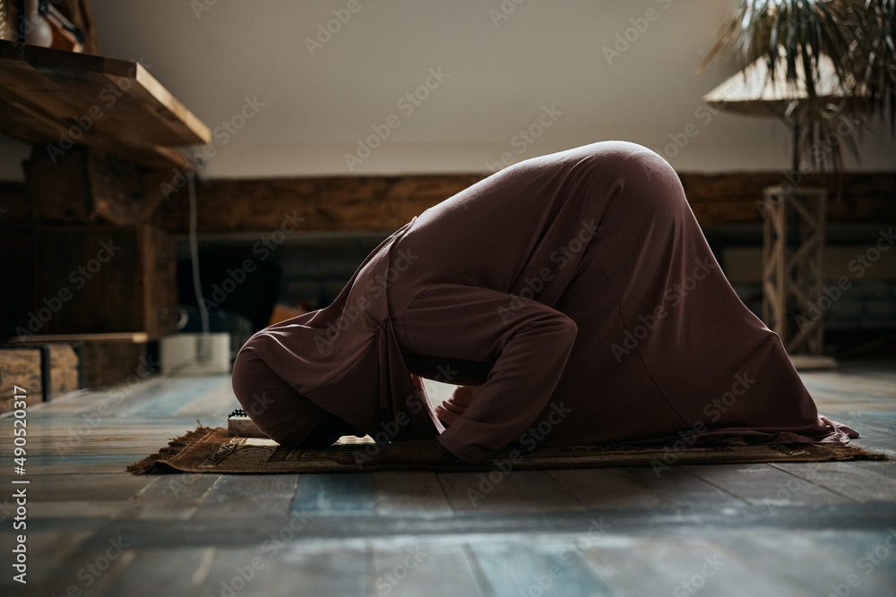 Religious Muslim woman in sajdah pose prays at home. Stock Photo ...