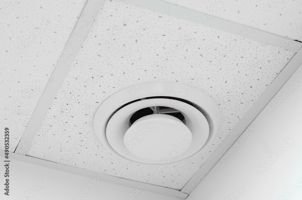 Round ventilation duct on the ceiling. Modern ventilation built into ...