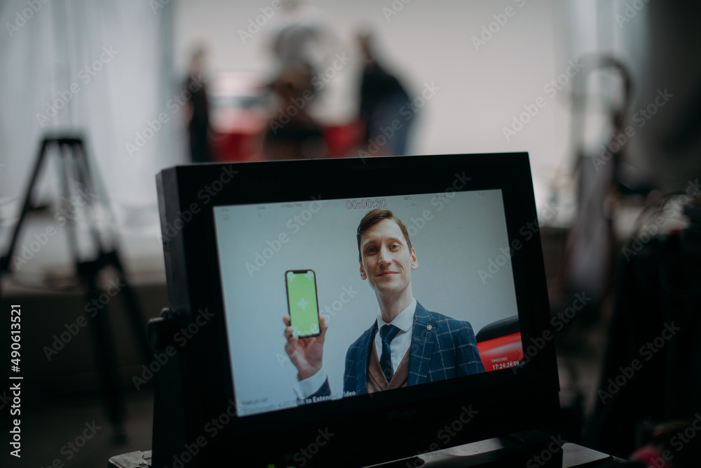 Professional male actor works in the frame on the set. Shooting with a ...