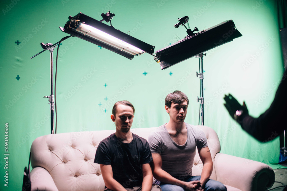 Professional male actors work in the frame on the set. Shooting with ...