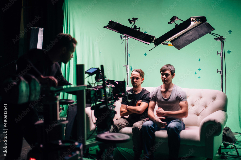 Professional male actors work in the frame on the set. Shooting with ...
