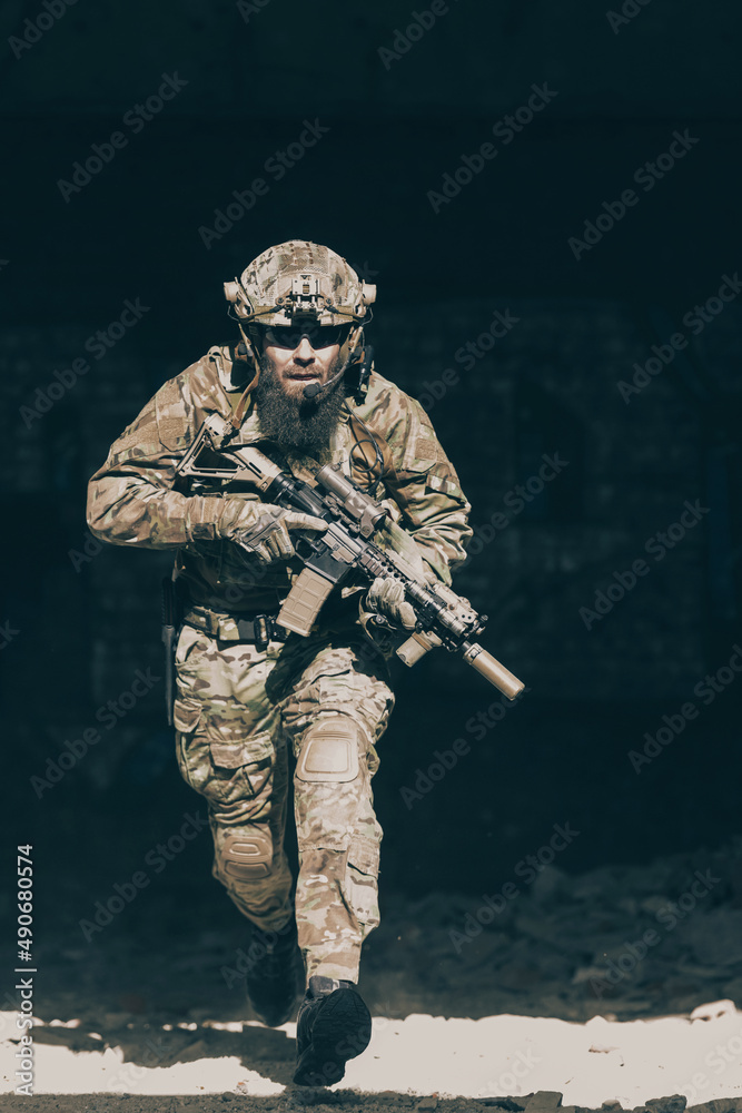 A bearded soldier in uniform of special forces in a dangerous military ...