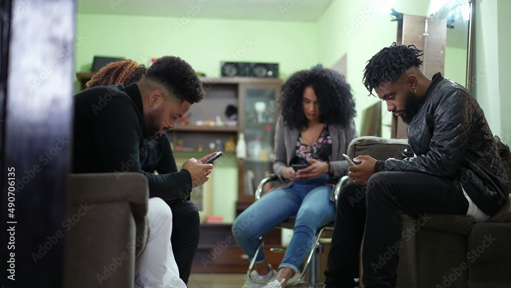 People hanging out staring at phones each person in their own ...