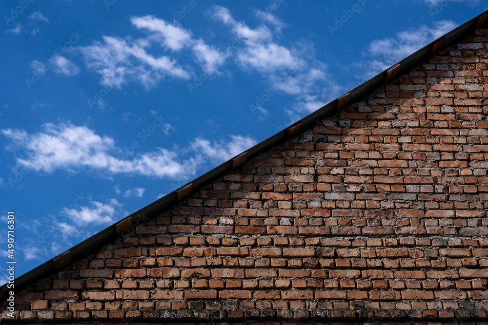 a large old brick part of the roof of a building that forms a triangle ...