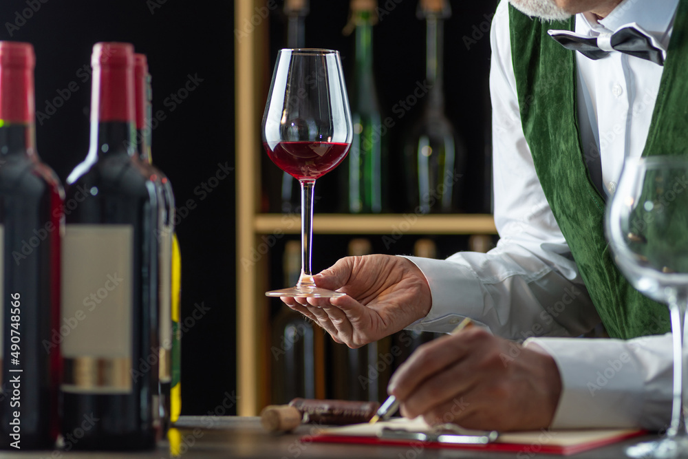 Sommelier with a glass of wine. Examination of wine products ...