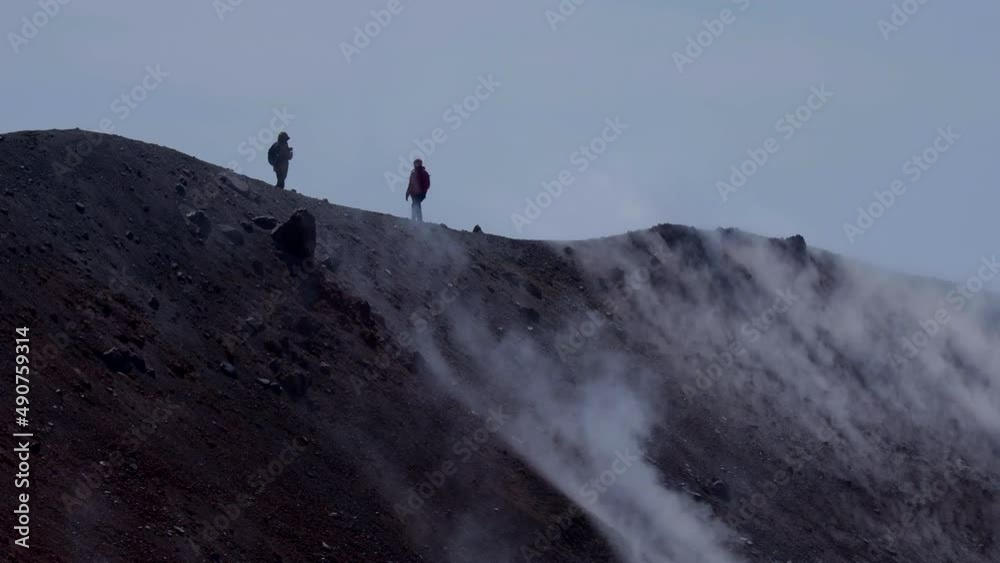 Silhouette of man hiking at coldera of Avachinsky stratovolcano, also ...