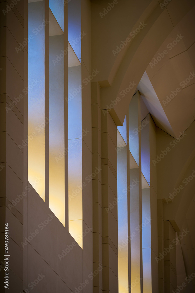 Stained glass window reflections throw pastel colors of blue and yellow ...