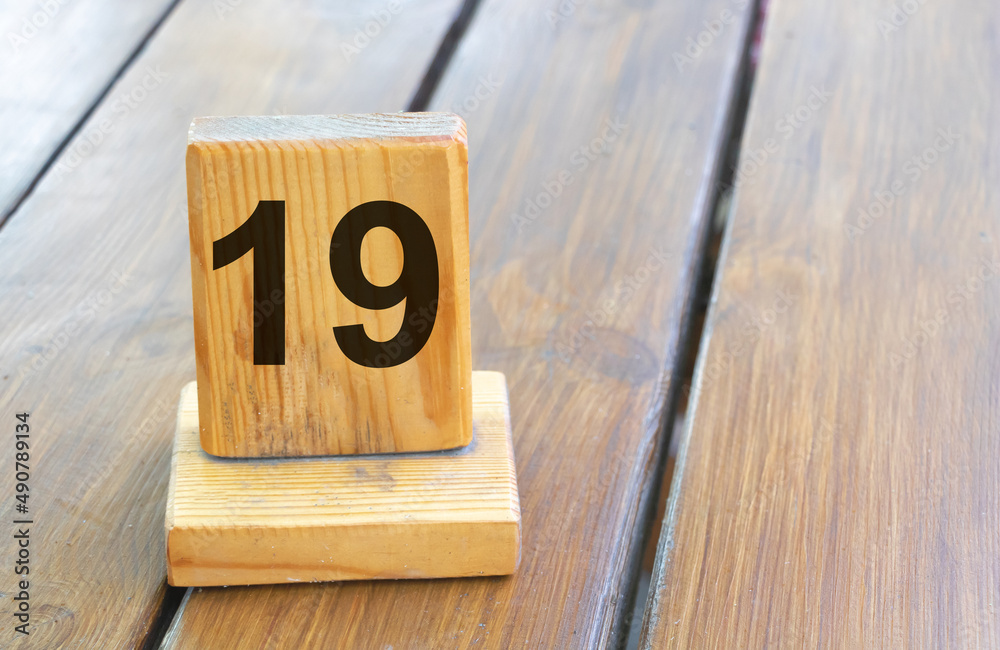 Wooden priority number 19 on a plank tab Stock Photo | Adobe Stock