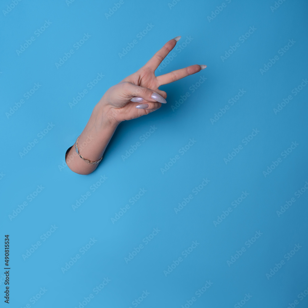 Two thumbs up, the winning symbol. A beautiful woman's hand with a ...