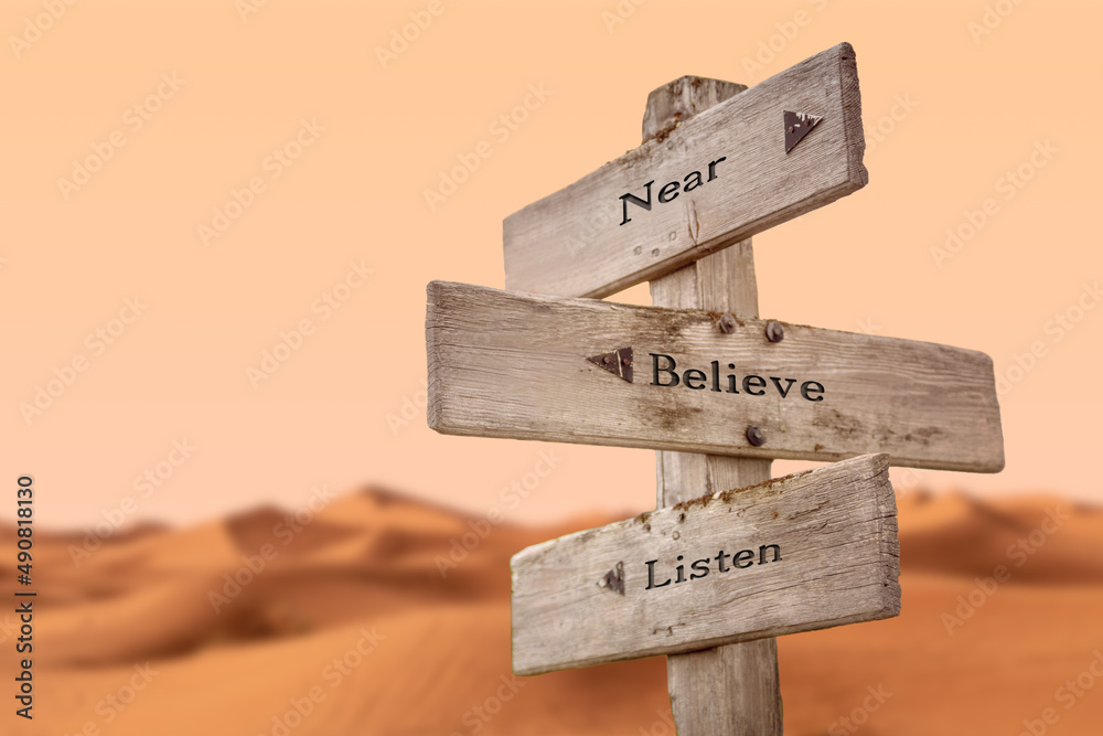 near believe listen text quote on wooden signpost outdoors in dry ...
