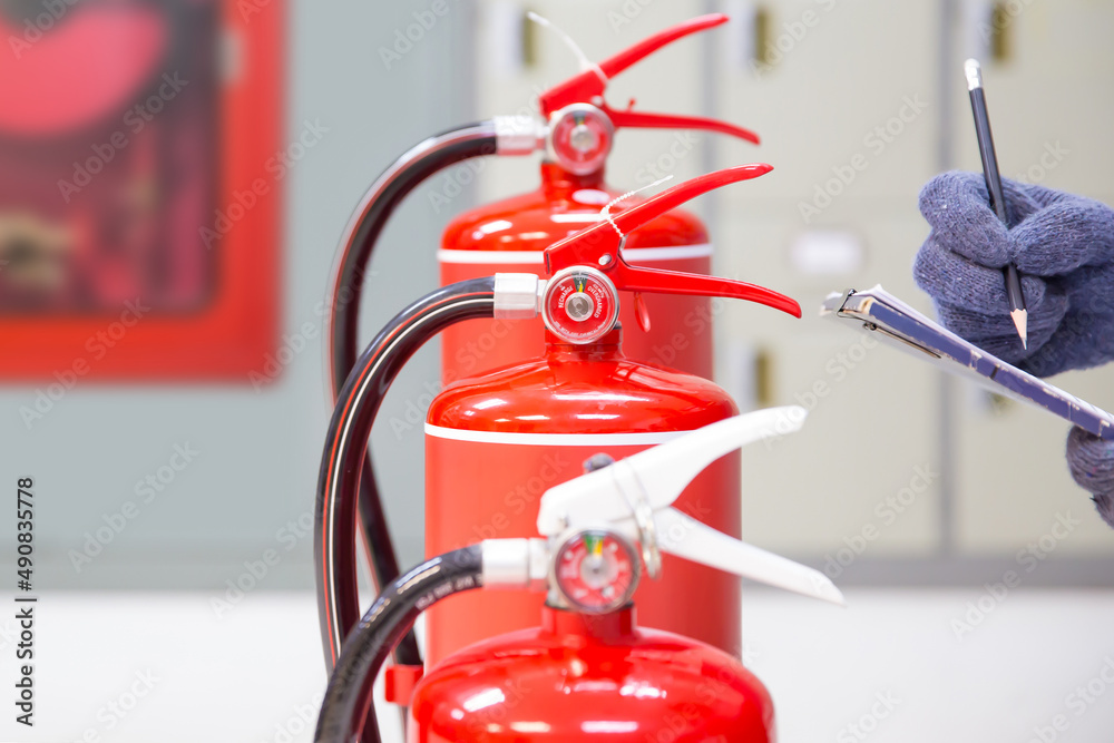Fire extinguisher has hand engineer inspection checking pressure gauges ...