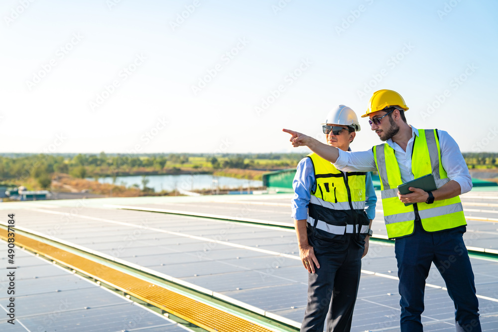 Professional engineer using drone and digital tablet maintaining solar ...