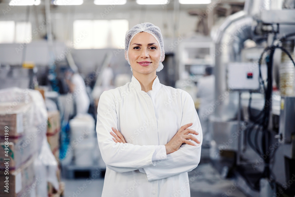 Portrait of successful food factory worker smiling at the camera. Stock ...