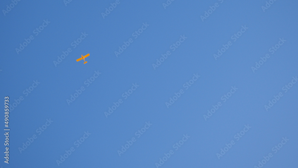Light aircraft flies in the clear blue sky. Wallpaper or background ...