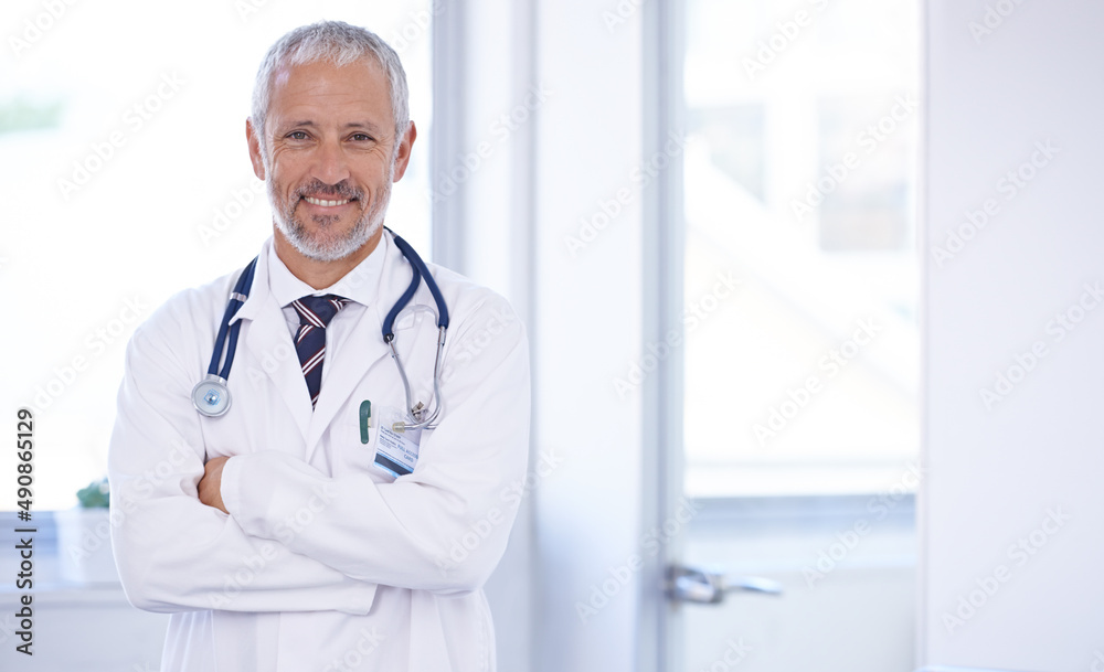 The trusted family doctor. Portrait of a doctor standing in a well-lit ...