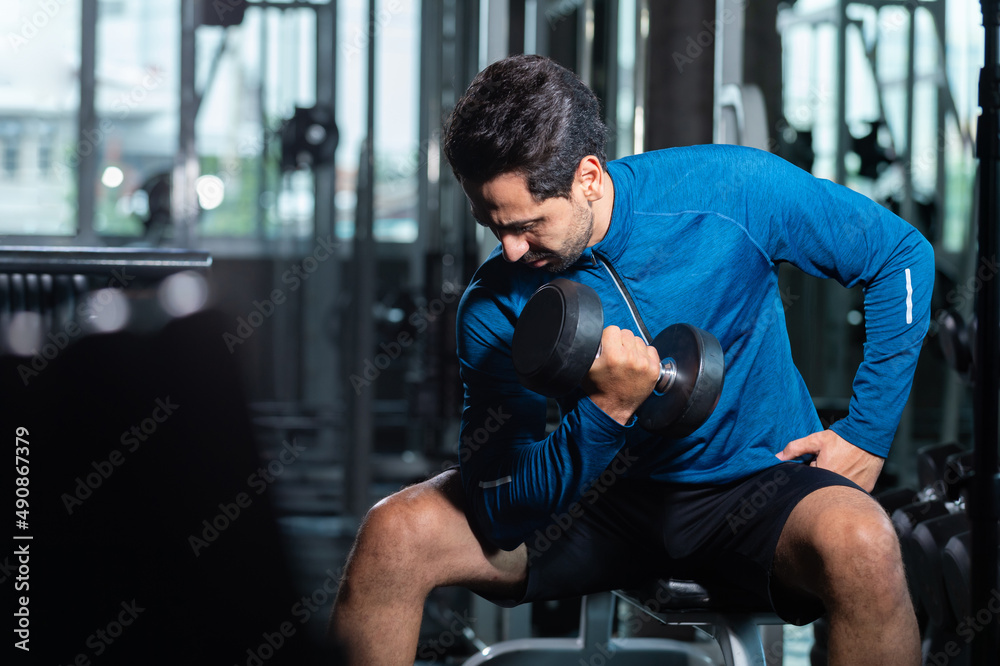 Healthy Caucasian athlete man workout exercise weight lifting dumbbell ...