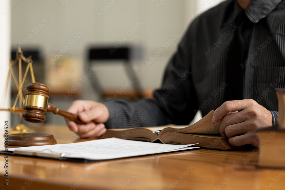 A person holding the hammer of justice, the concept of a lawyer or a ...