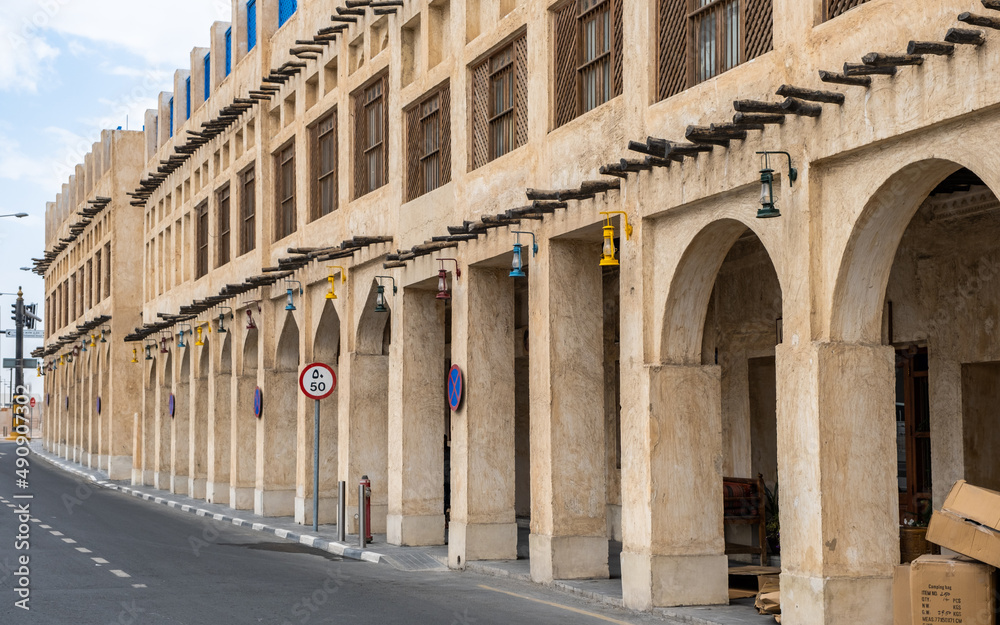 Middle eastern architecture with bamboo wooden poles sticking out of a ...