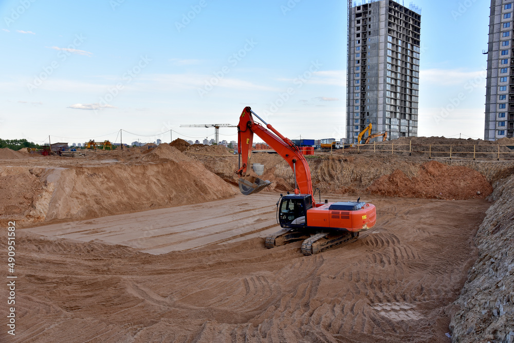 Excavator digging the pit foundation for buiding construction ...