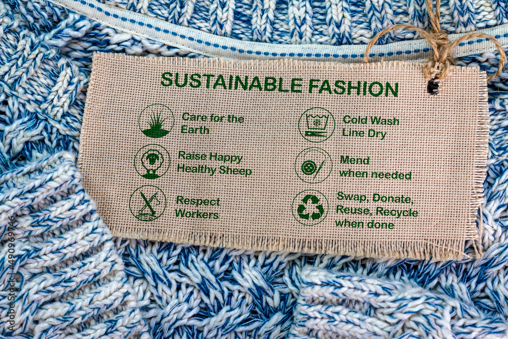 sustainable fashion label on woollen jumper with care icons and text ...