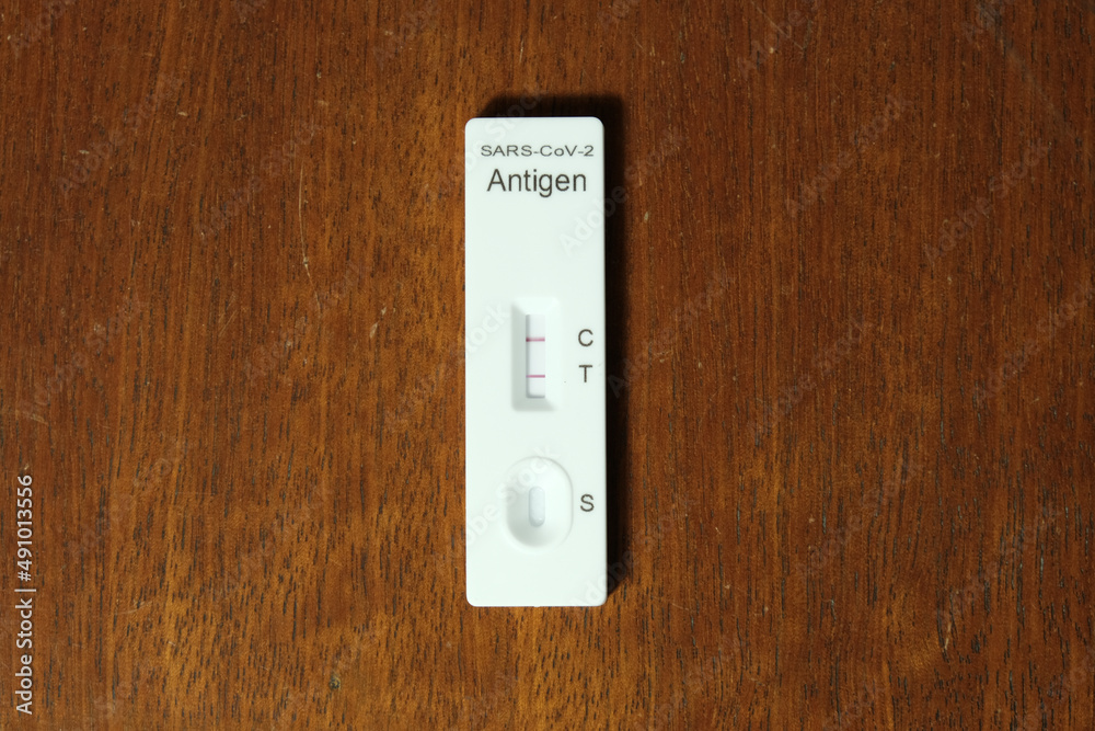 A picture of covid-19 self test kit showing positive result on the ...