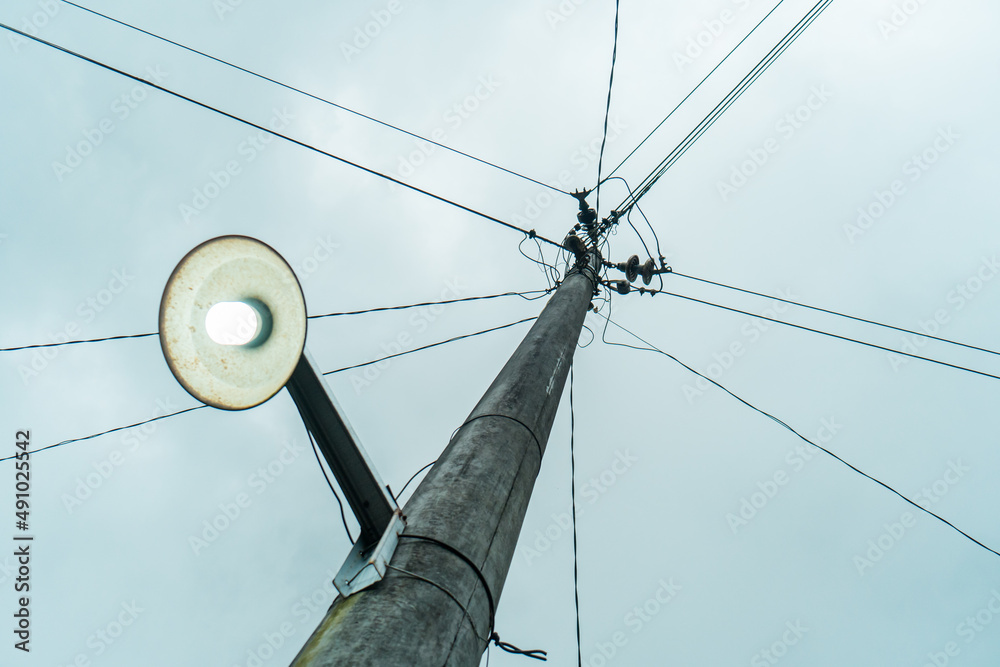 Street electric pole with many electrical wires and fiber optic cables ...