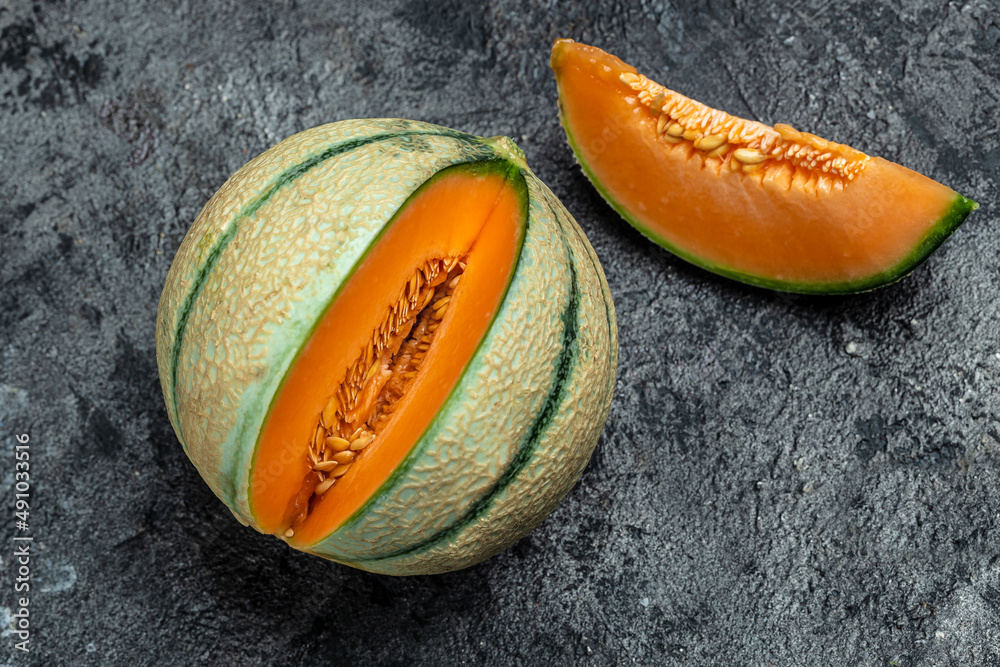 cantaloupe melon. whole and slice of japanese melons, orange melon with ...