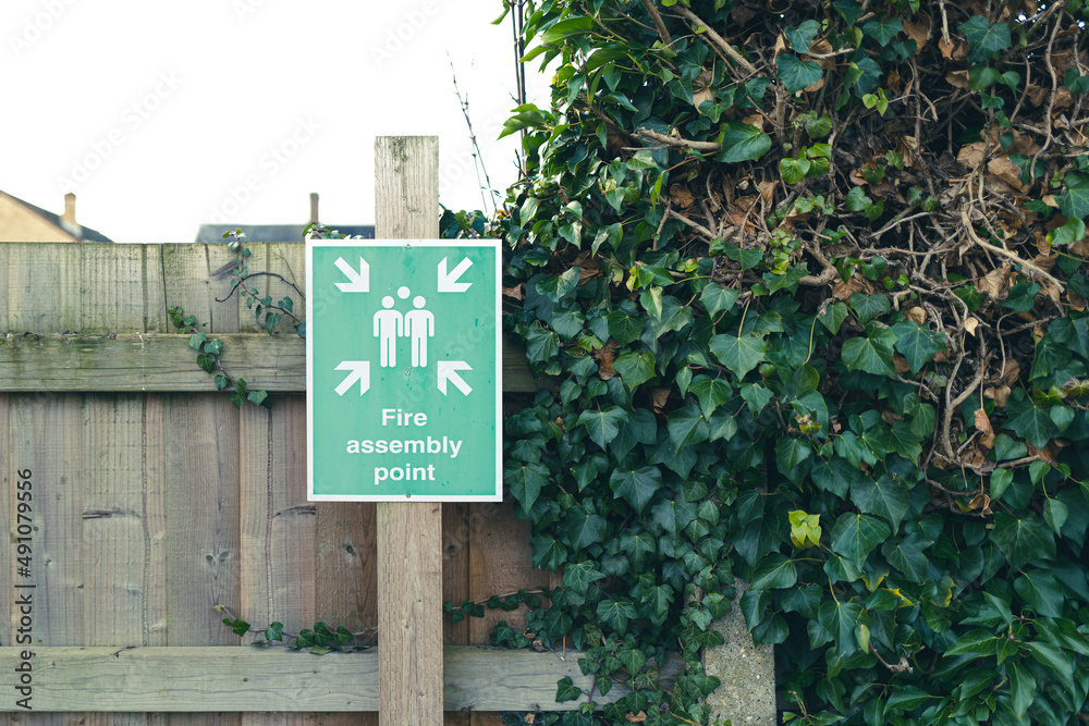 Generic Fire Safety Sign seen erected on a wooden fence, which is ...